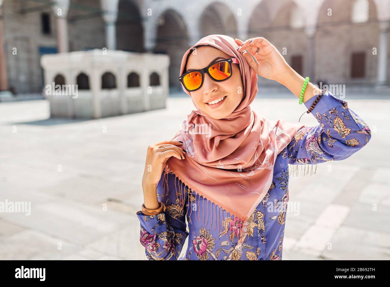 Happy attractive muslim woman travel in Turkey, posing in courtyard of ...