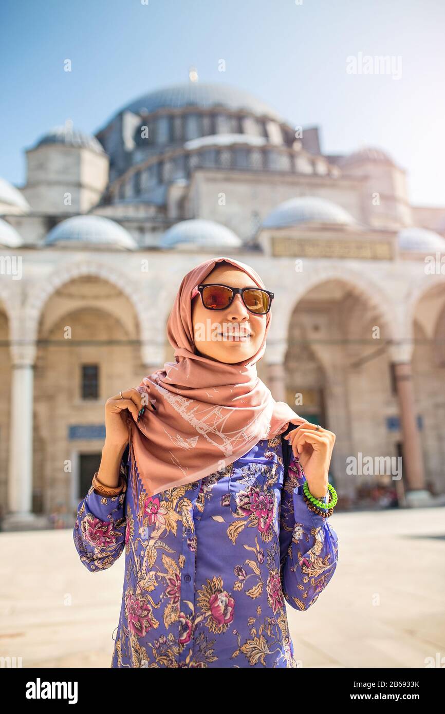 Happy attractive muslim woman travel in Turkey, posing in courtyard of ...