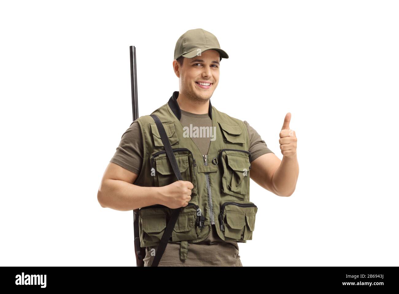 Young hunter with a shotgun on his shoulder showing thumbs up sign ...