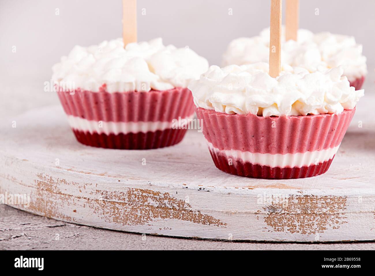 Strawberry ice cream popsicle lollies with whipped cream frozen in ...