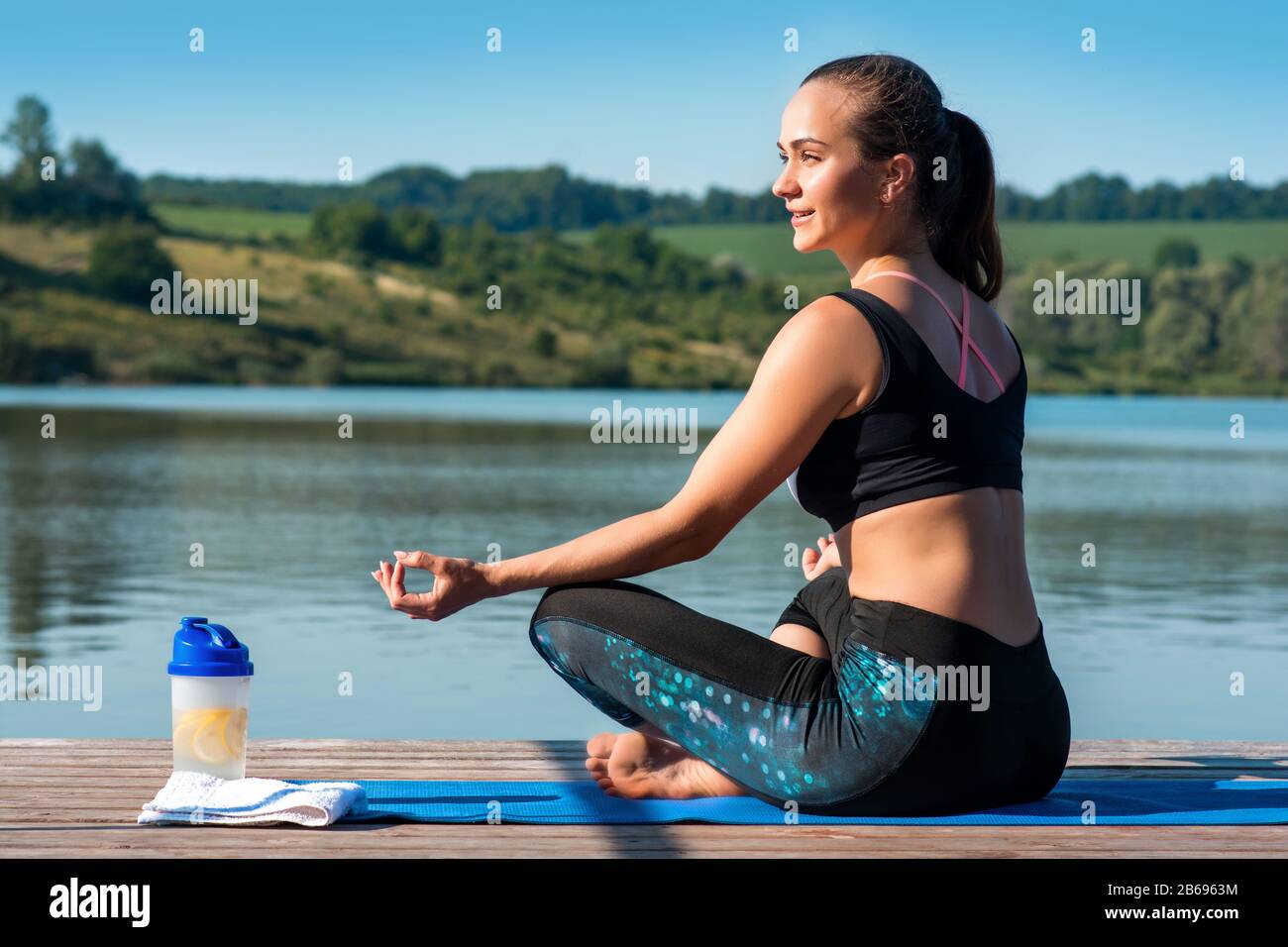 Girl does the splits on the background of beautiful nature. Yoga ...
