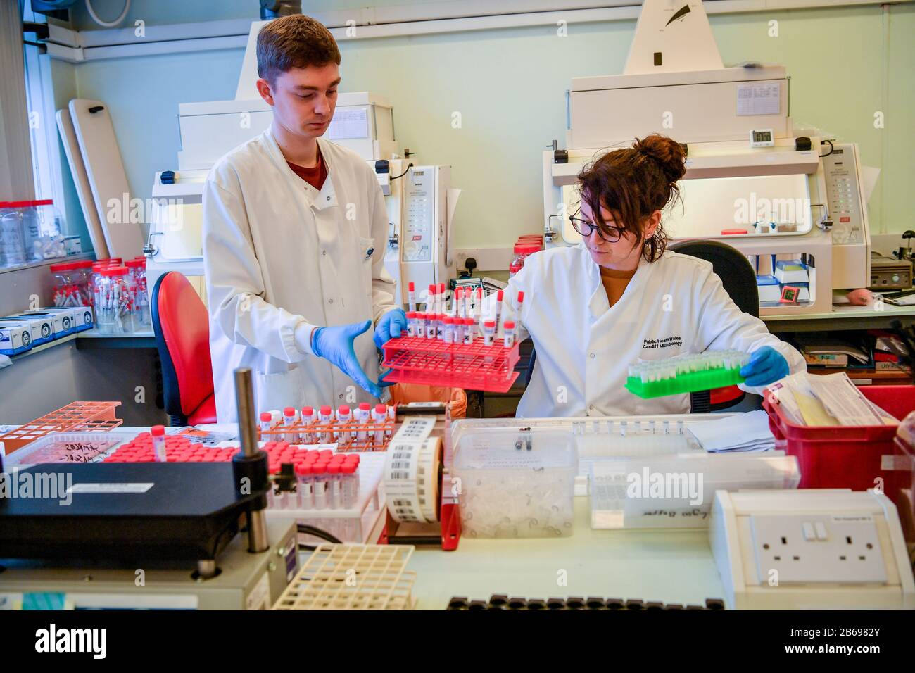 Lab technicians handle suspected COVID-19 samples as they carry out a ...