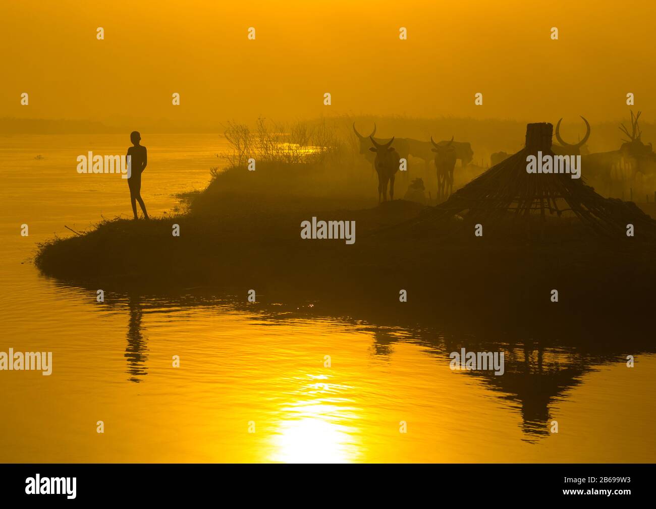 Mundari tribe child on the bank of river Nile at sunset, Central ...