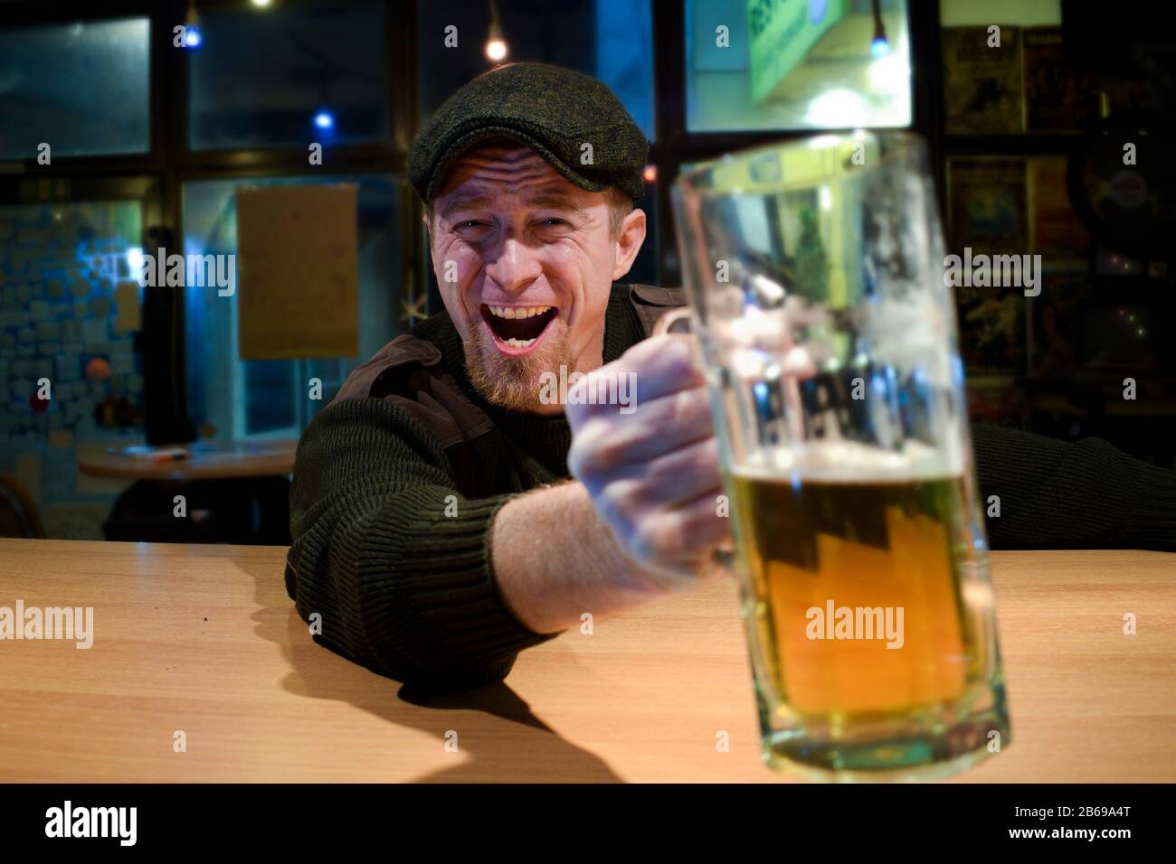 Red haired almost Irish guy seating in the bar and drinks some beer and ...