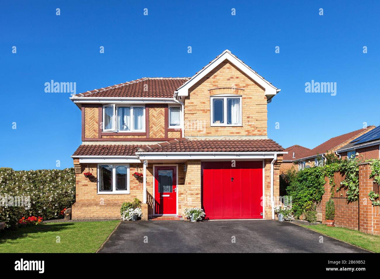 Beautiful detached house with red door Stock Photo - Alamy