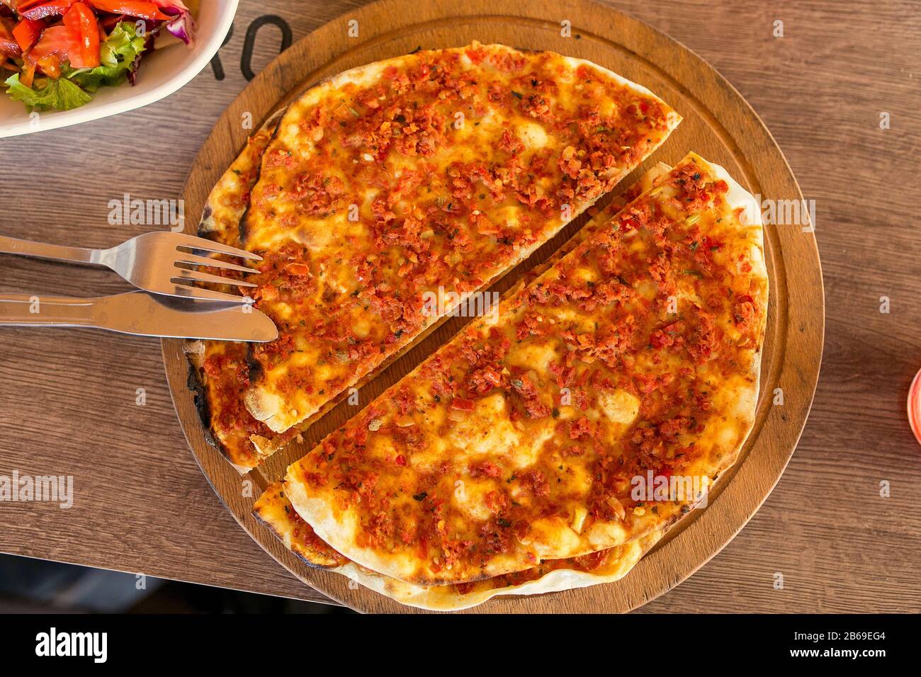 Lahmacun traditional turkish food with minced beef meat, on cafe table ...