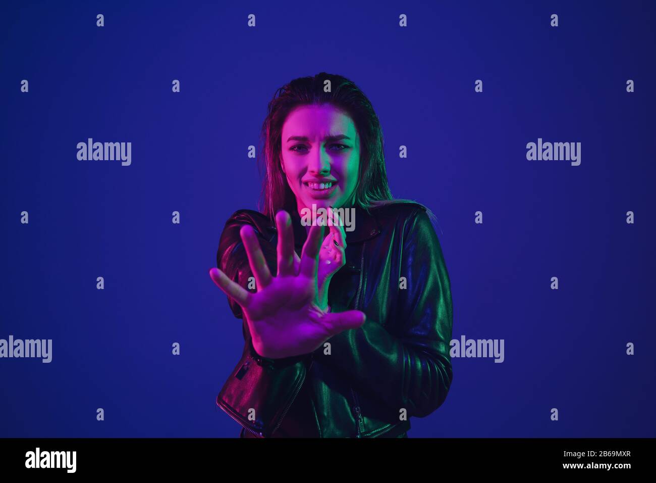 Shocked, scared, rejecting. Caucasian woman's portrait isolated on blue ...