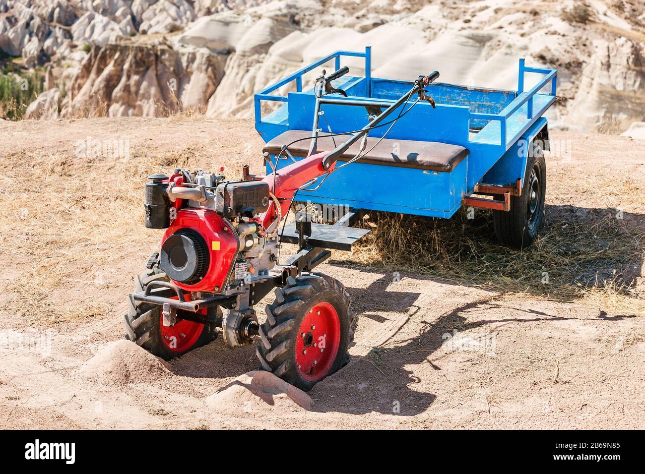 The small handy farm machine motor plow with cart closeup standing in ...