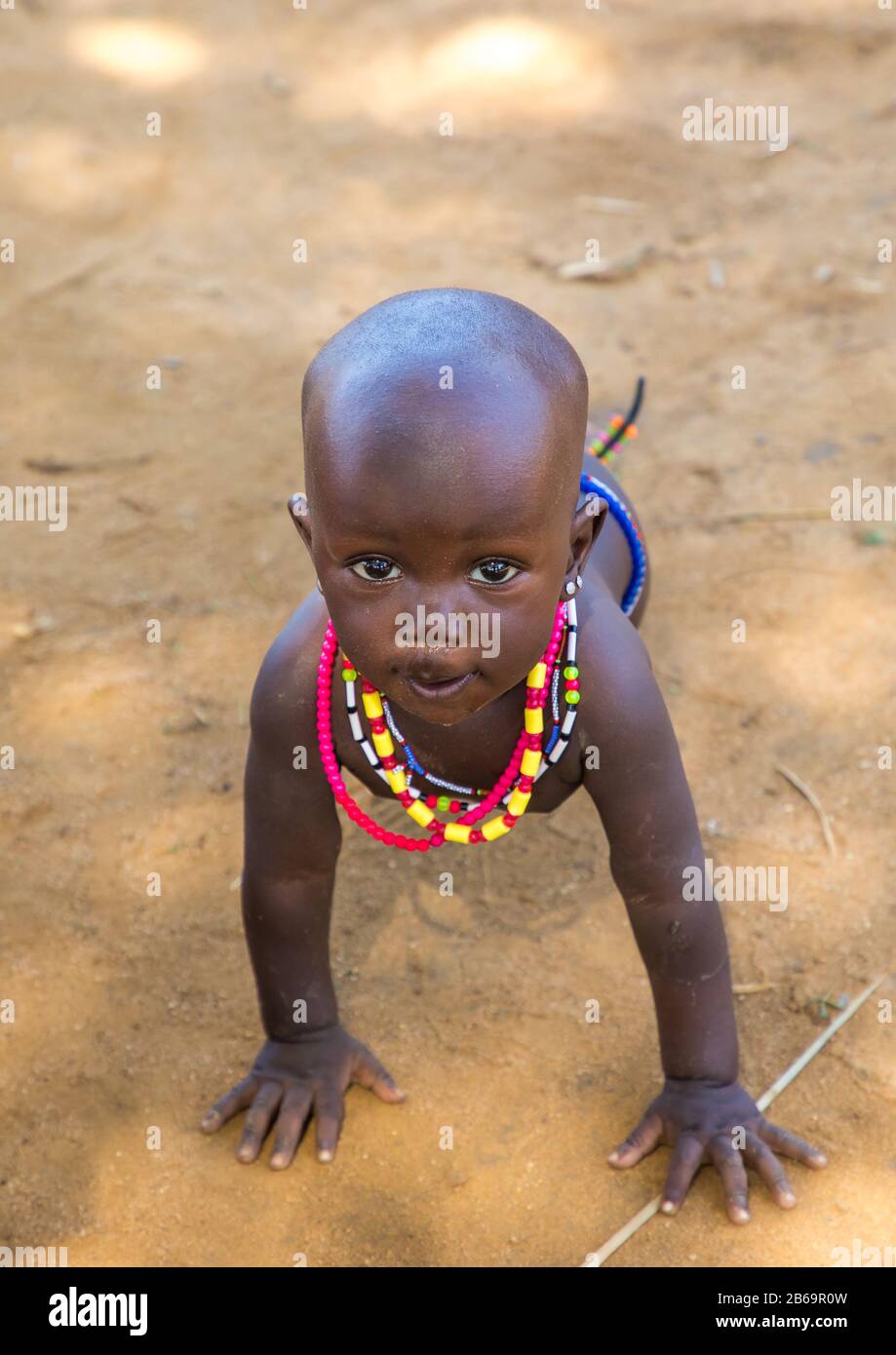 Larim tribe baby girl on all fours, Boya Mountains, Imatong, South ...