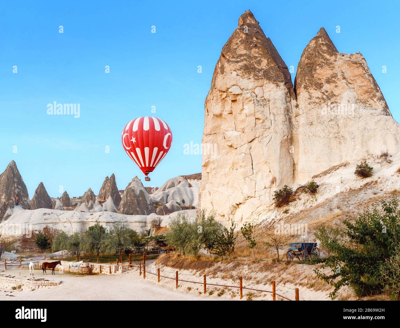 Hot air balloon flying over horse corral in Cappadocia Stock Photo - Alamy