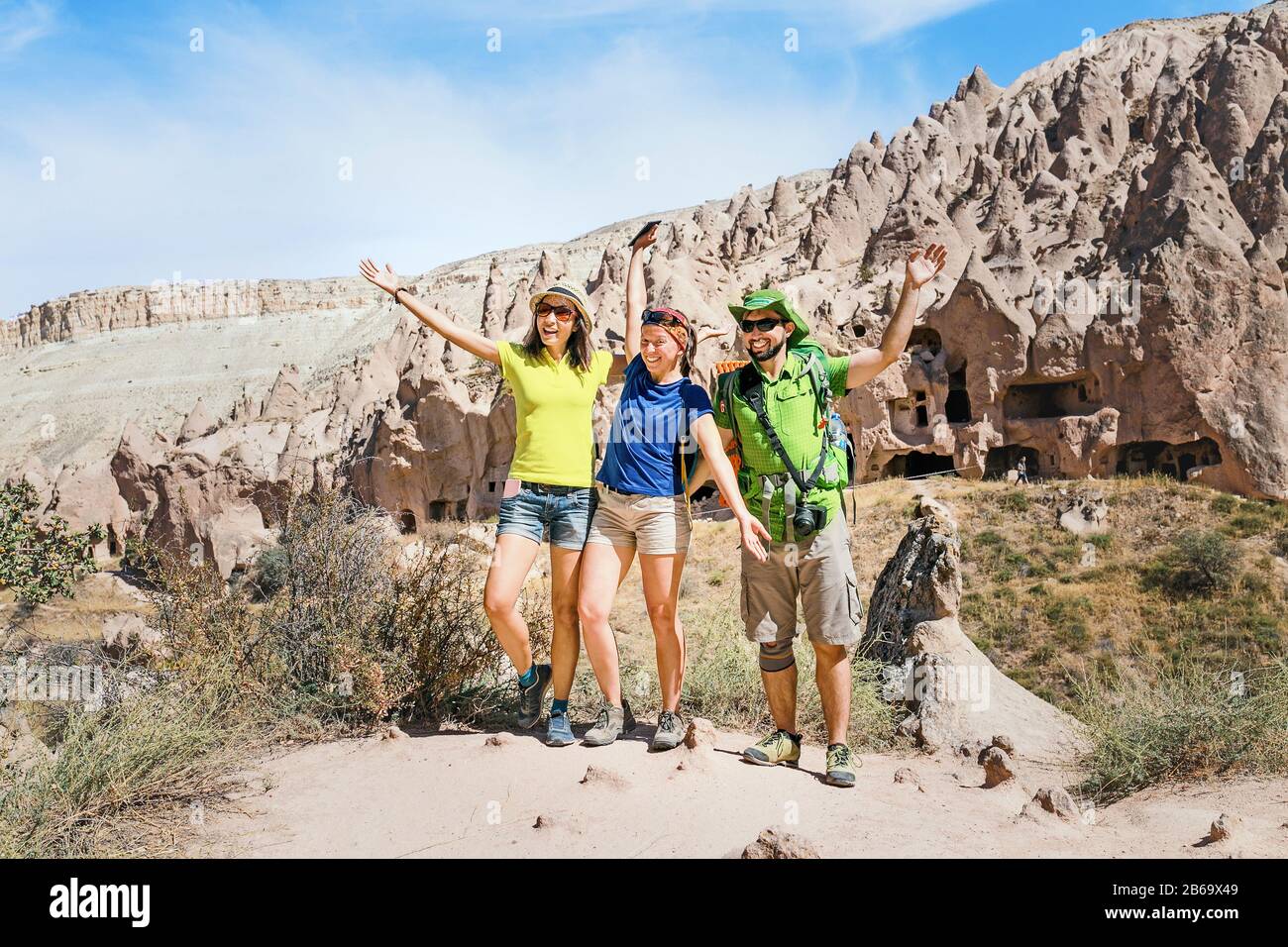 Multicultural friends travel and having fun at old ancient Zelve town ...