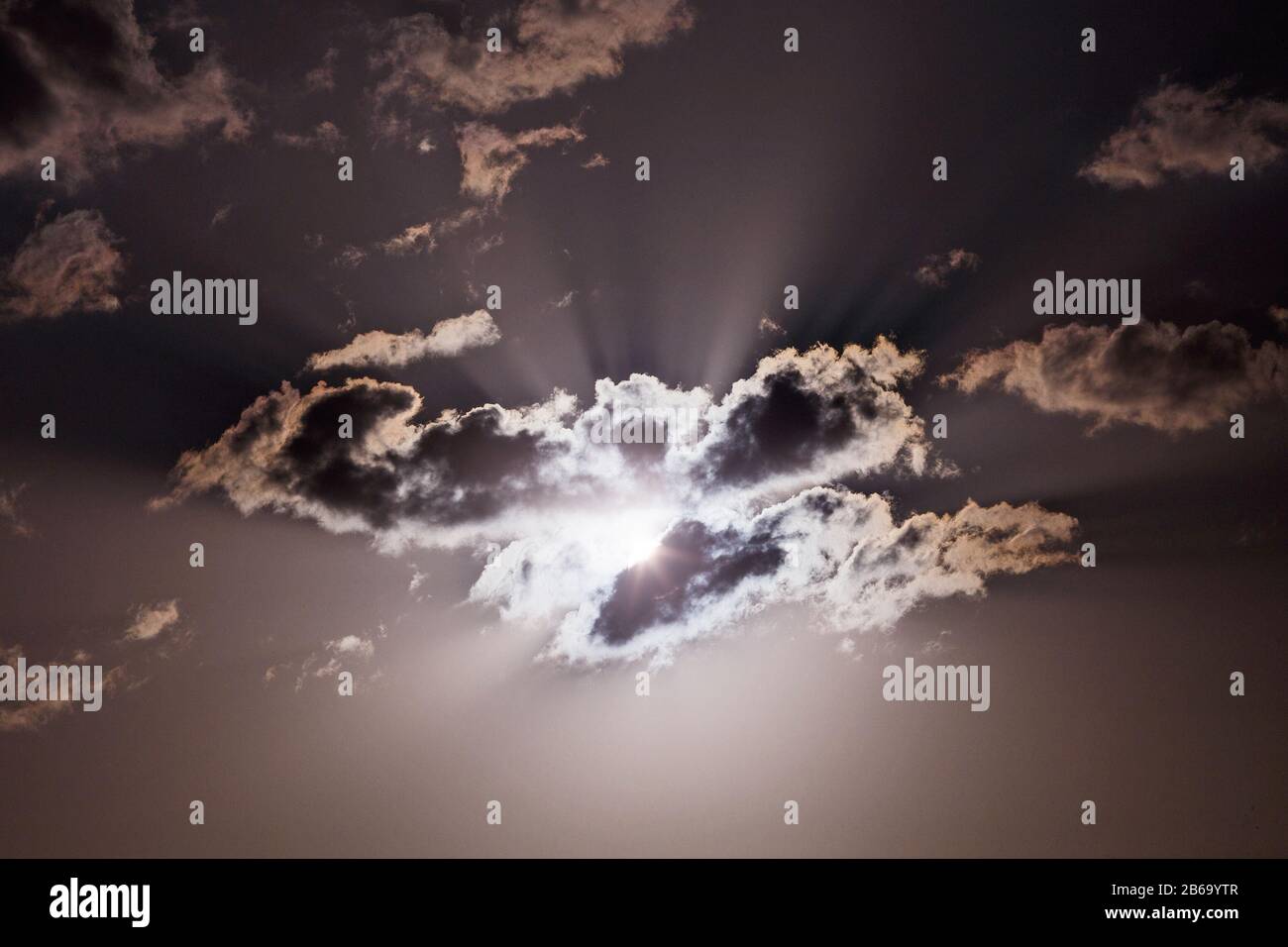 Blackened sun beside clouds Stock Photo - Alamy