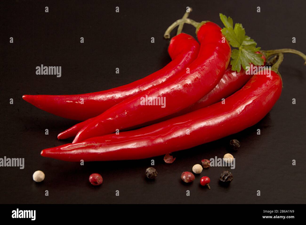 Red chili pepper on black background. Composition of group burning ...