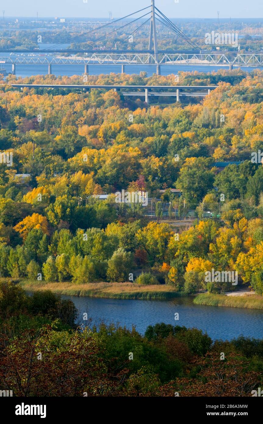 Kiev bridges and blue Dnieper river surrounded with multicolored autumn ...