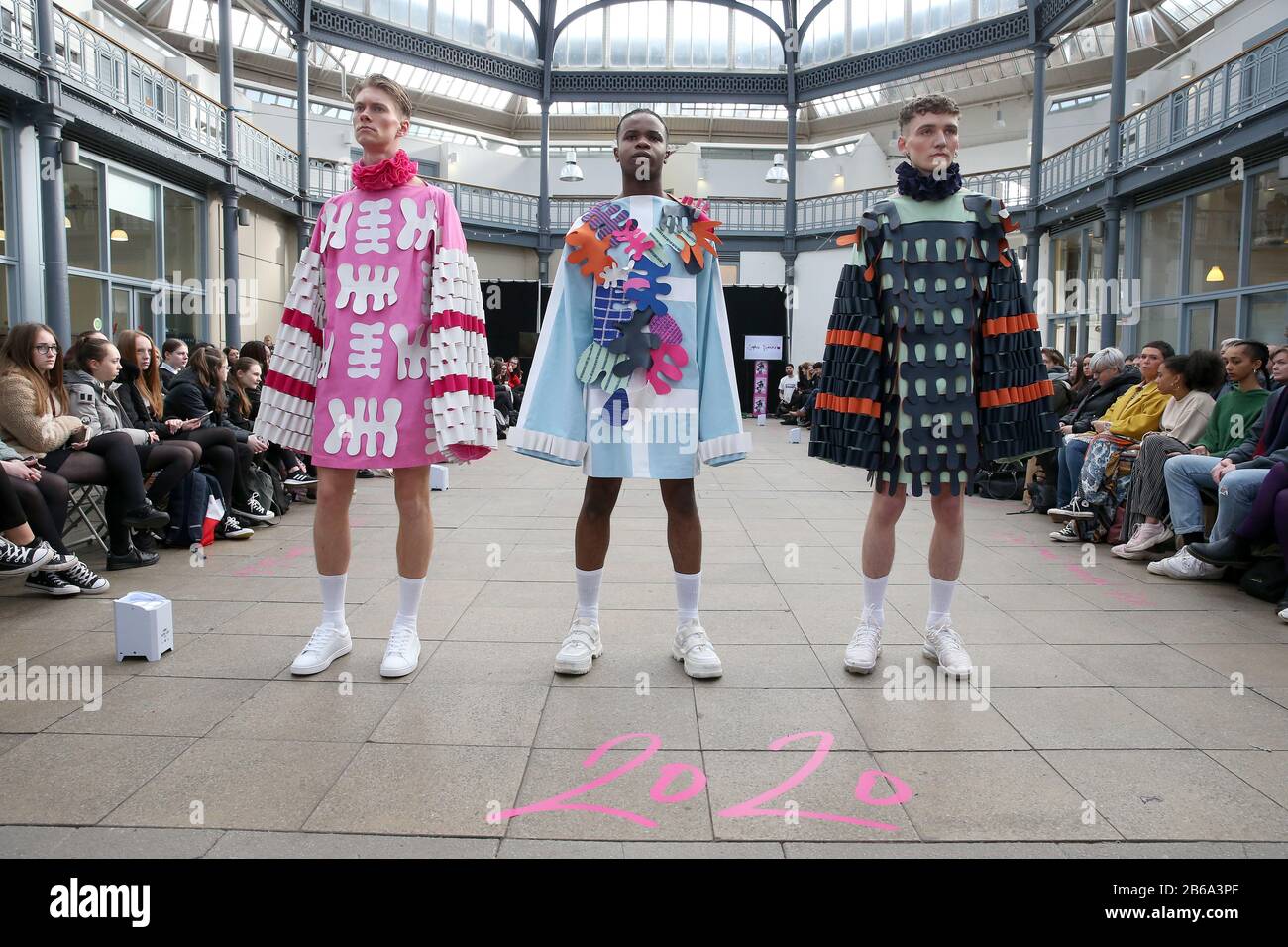 Models wear outfits designed by fashion design students as they take ...