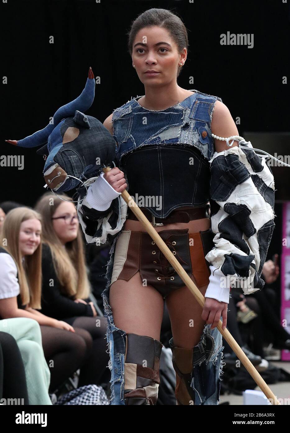 Models wear outfits designed by fashion design students as they take ...