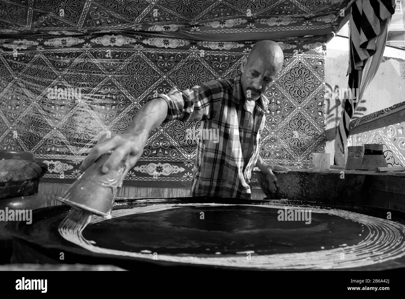 Alexandria, Egypt February 6, 2019 Konafa maker and seller during the ...