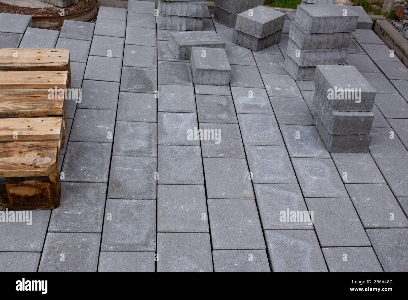 Concrete paver blocks laid beside a building, some paving stones are ...