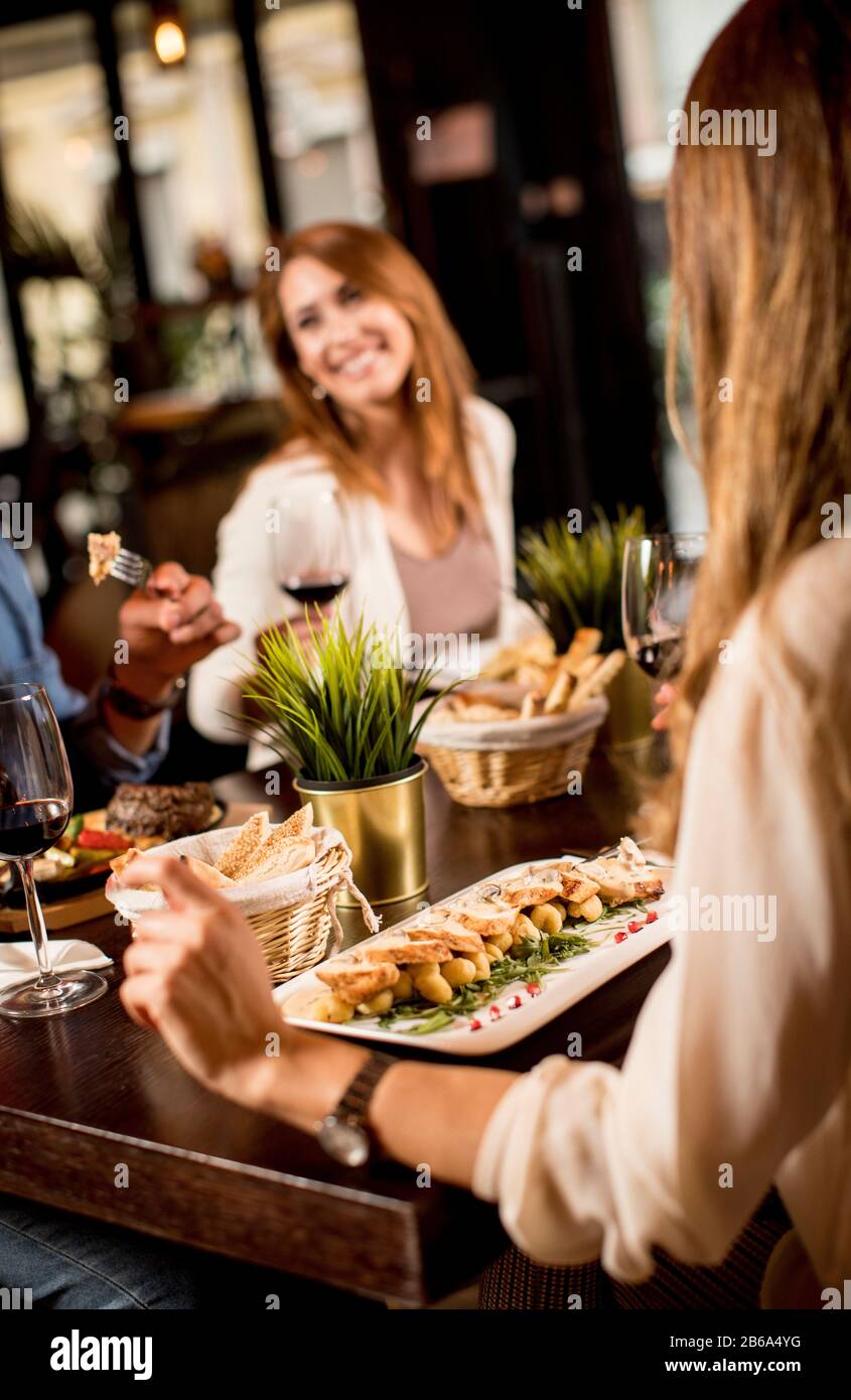 Two young women at a dinner in a modern restaurant Stock Photo - Alamy