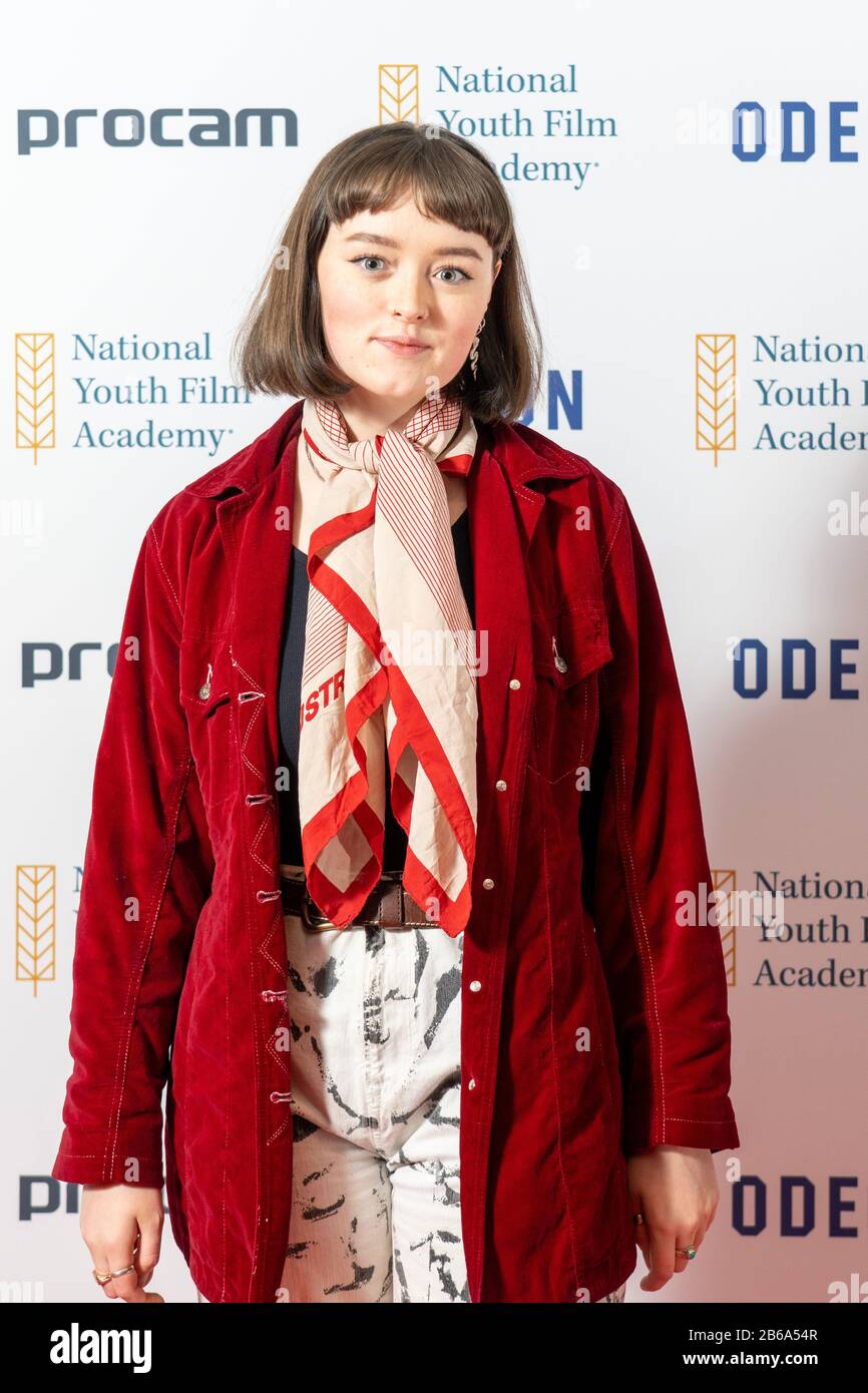 Mina Cuffwright posing for photos on the red carpet before attending ...