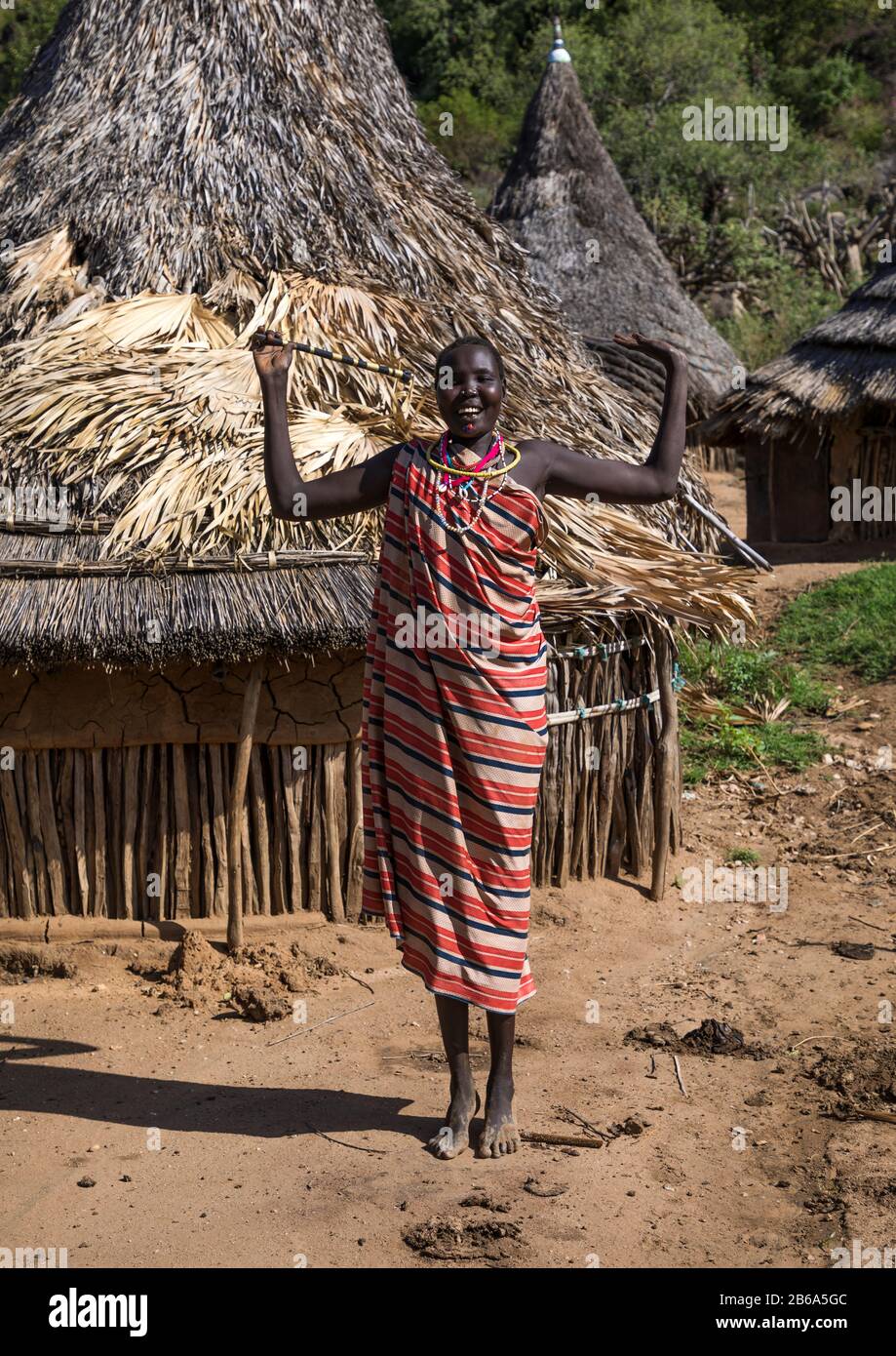 Larim tribe woman dancing with a traditional stick, Boya Mountains ...