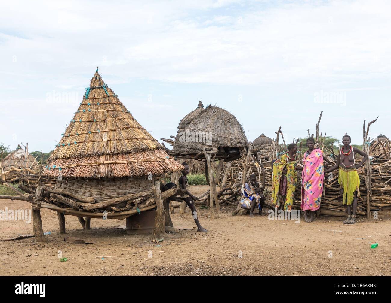 Toposa tribe women standing near a granary in a village, Namorunyang ...