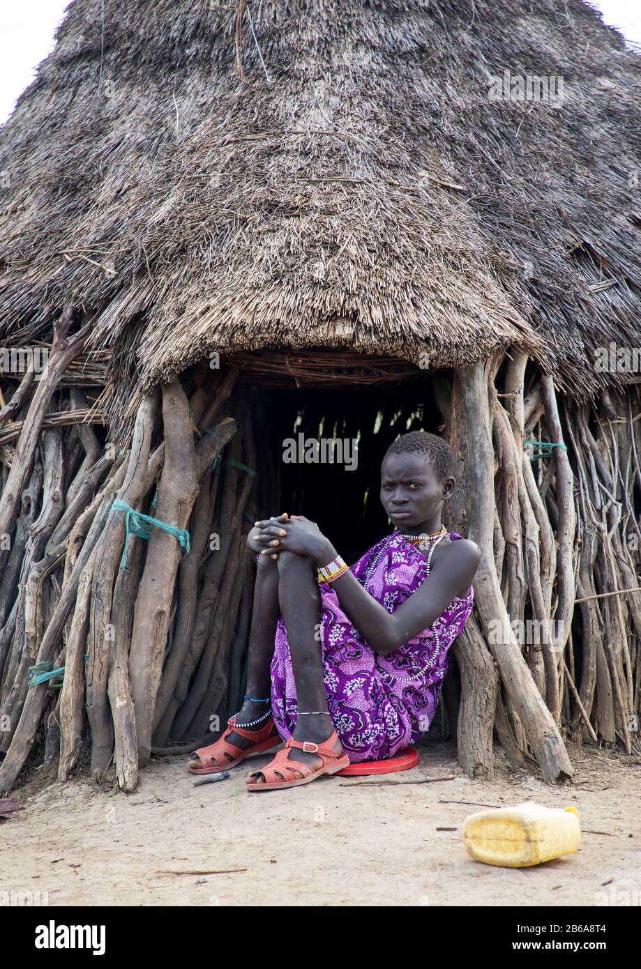 Toposa tribe woman sit at the entrance of her hut, Namorunyang State ...