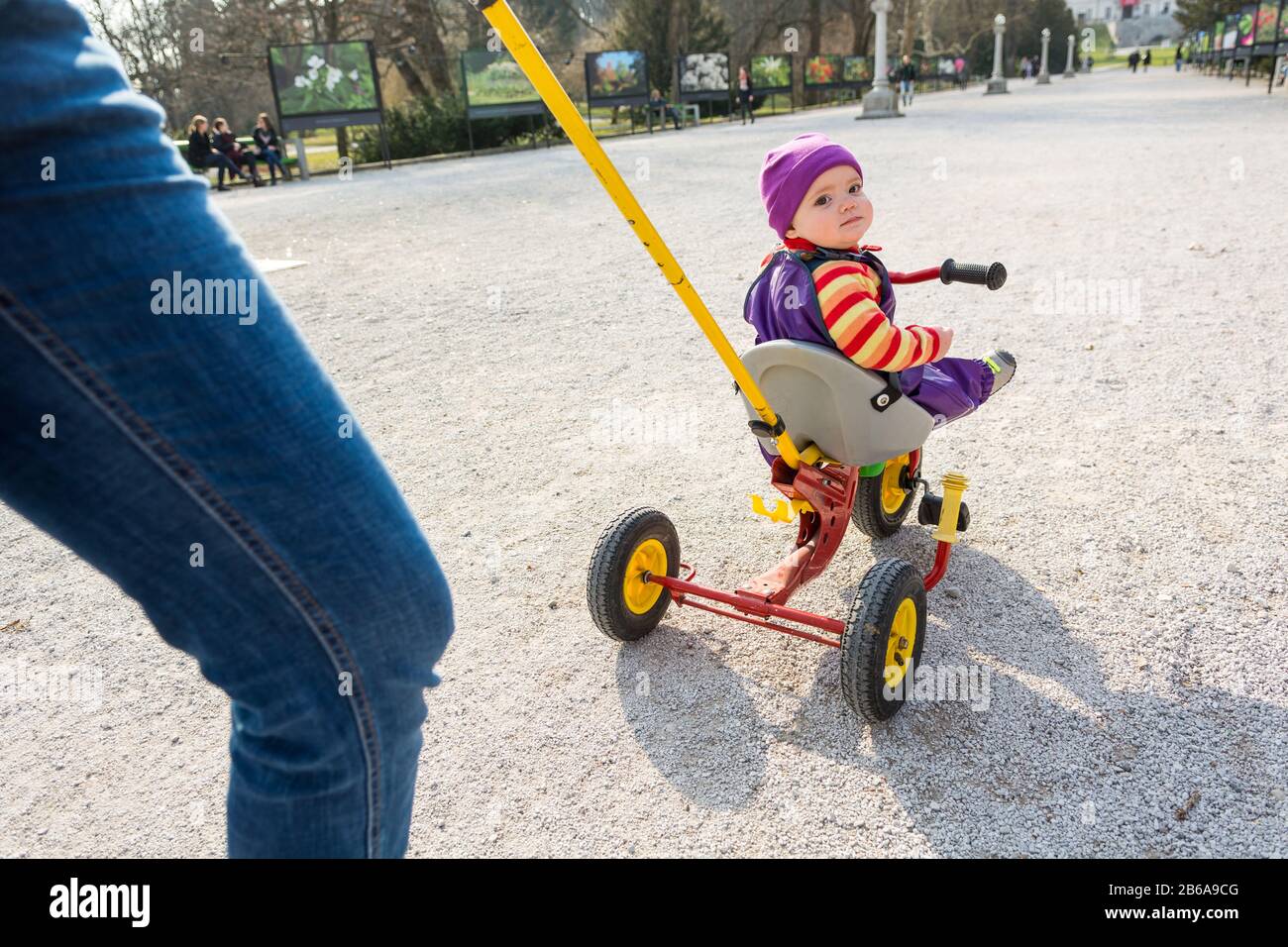 Cute baby girl enjoying her first bycicle ride with mothers help Stock ...