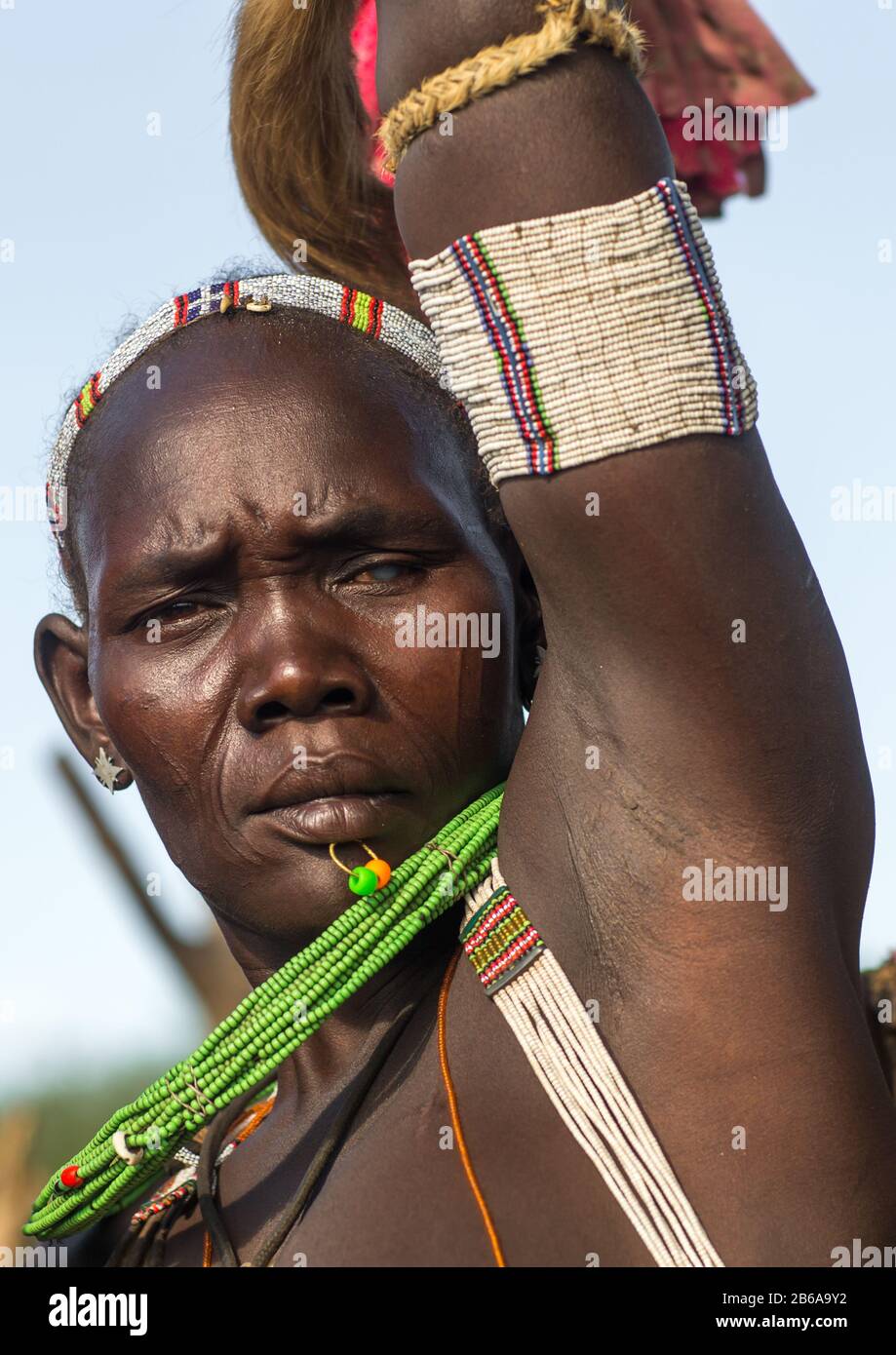 Toposa tribe woman in traditional clothing dancing during a ceremony ...