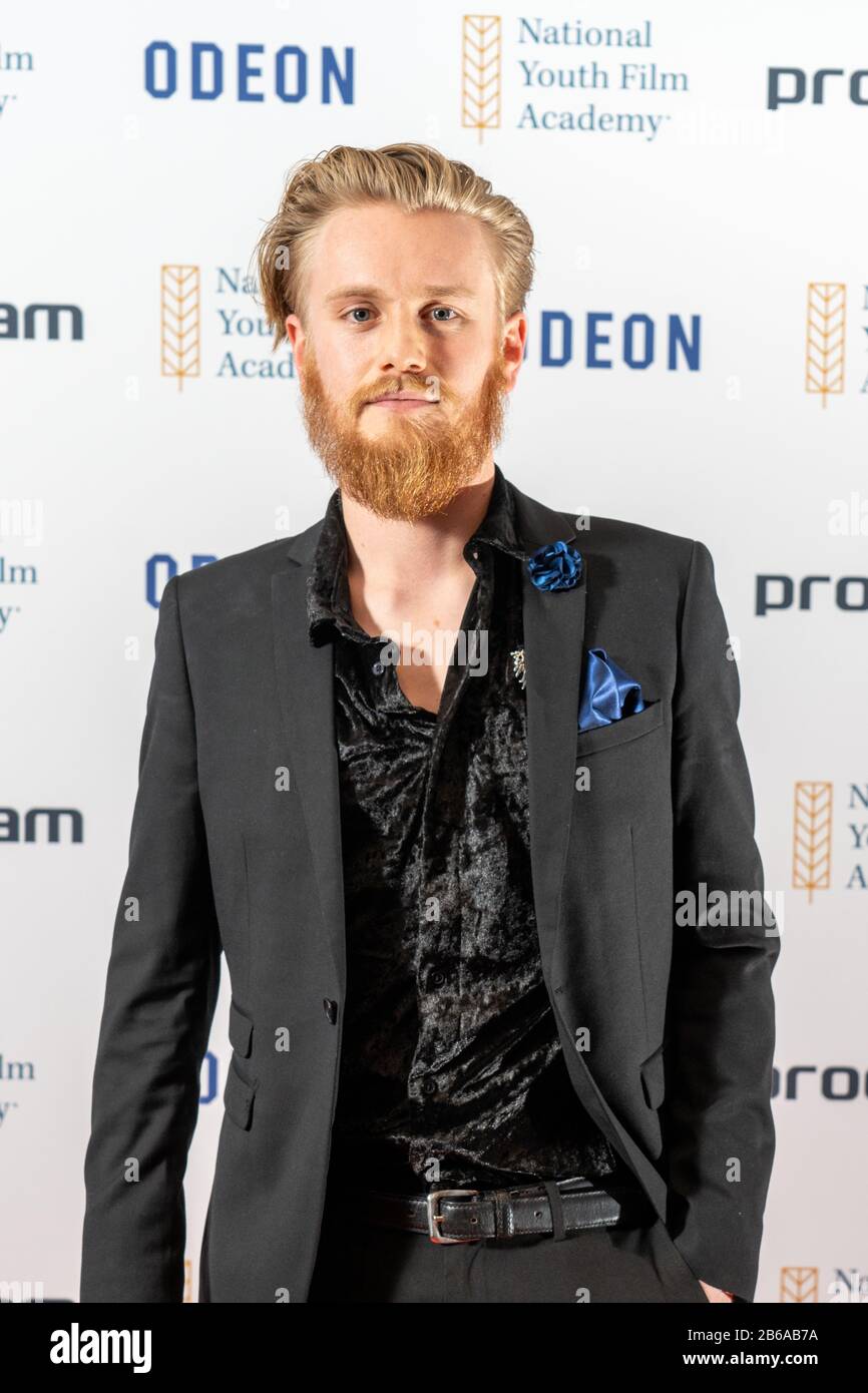 Harry Duff Walker posing for photos on the red carpet before attending ...