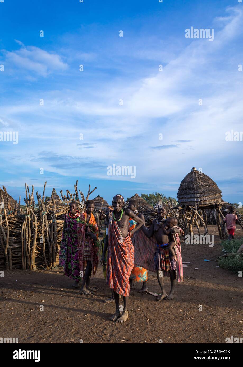 Toposa tribe people in a traditional village with granaries ...