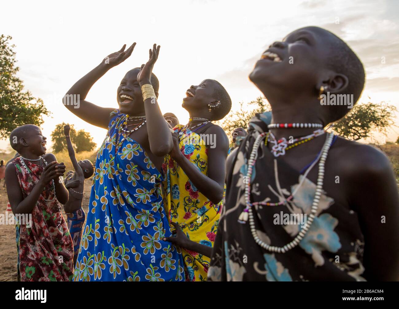Toposa tribe women in traditional clothing looking at the sky ...