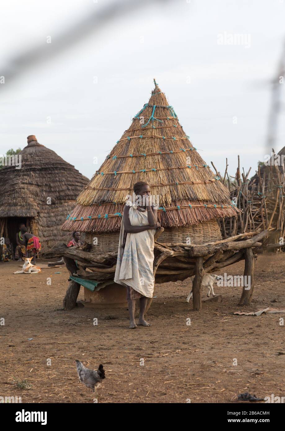 Portrait of a Toposa tribe woman in front of a granary, Namorunyang ...
