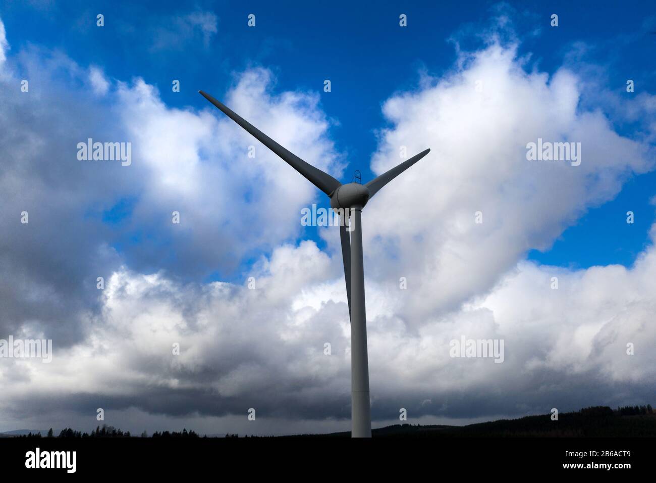 wind wheel in front a dark forest hills landscape and cloudscape Stock ...