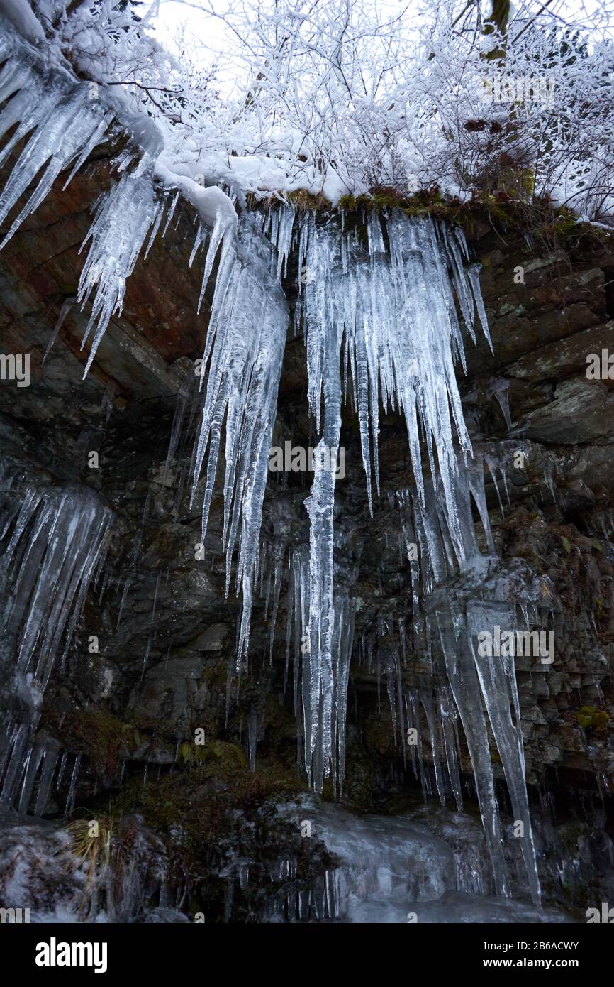 Crystal clear sharp icicles hanging down on the mountain Stock Photo ...