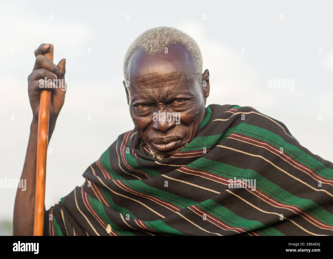 Toposa tribe senior man with a wood stick, Namorunyang State, Kapoeta ...
