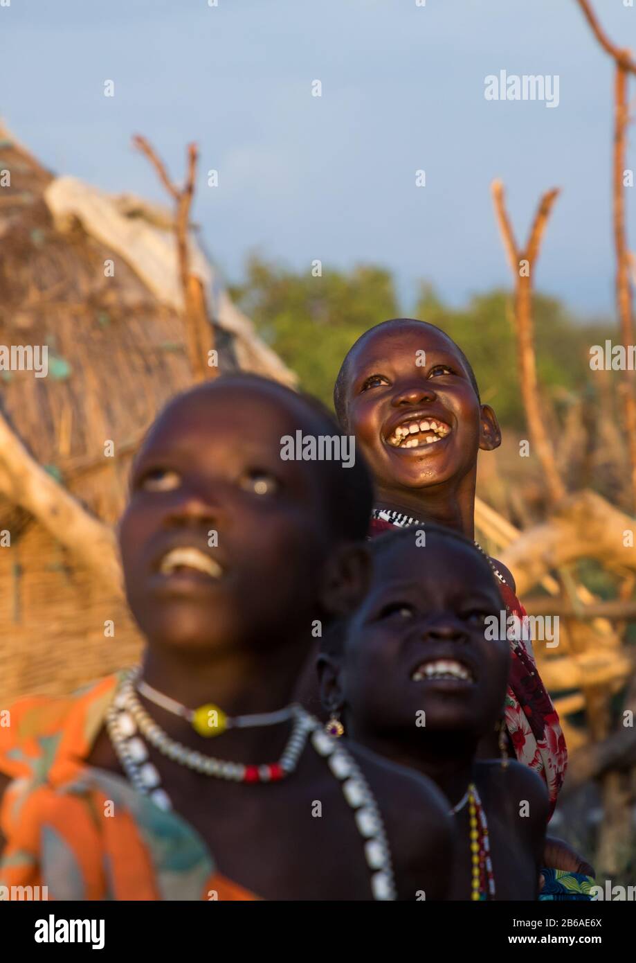 Laughing Toposa tribe children looking up in the sky, Namorunyang State ...