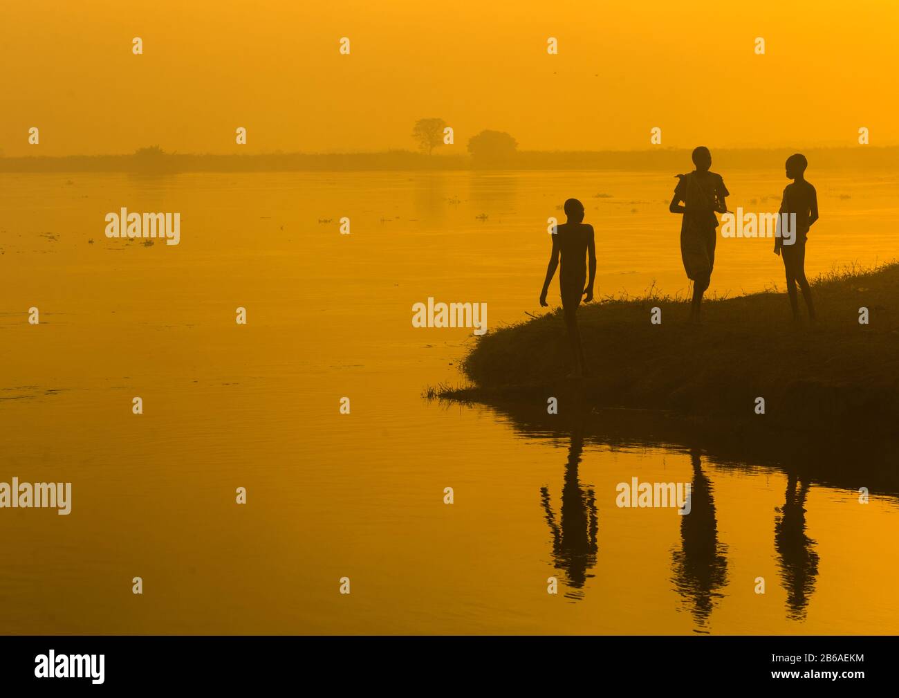 Mundari tribe people on the bank of river Nile at sunset, Central ...