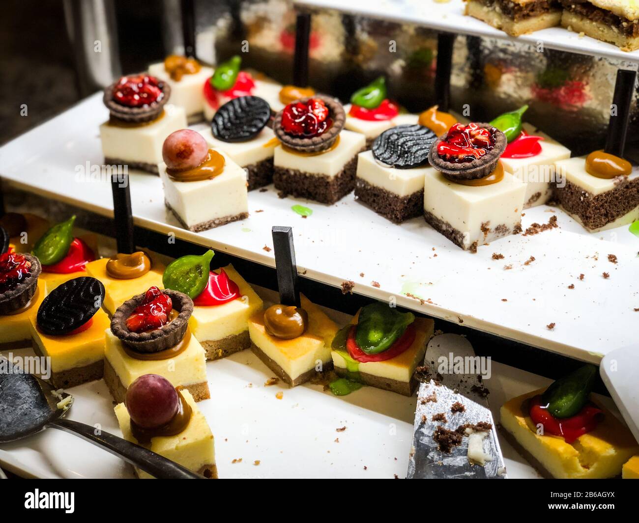 mix mini cakes & sweets with fresh fruits & glazed topping Stock Photo ...