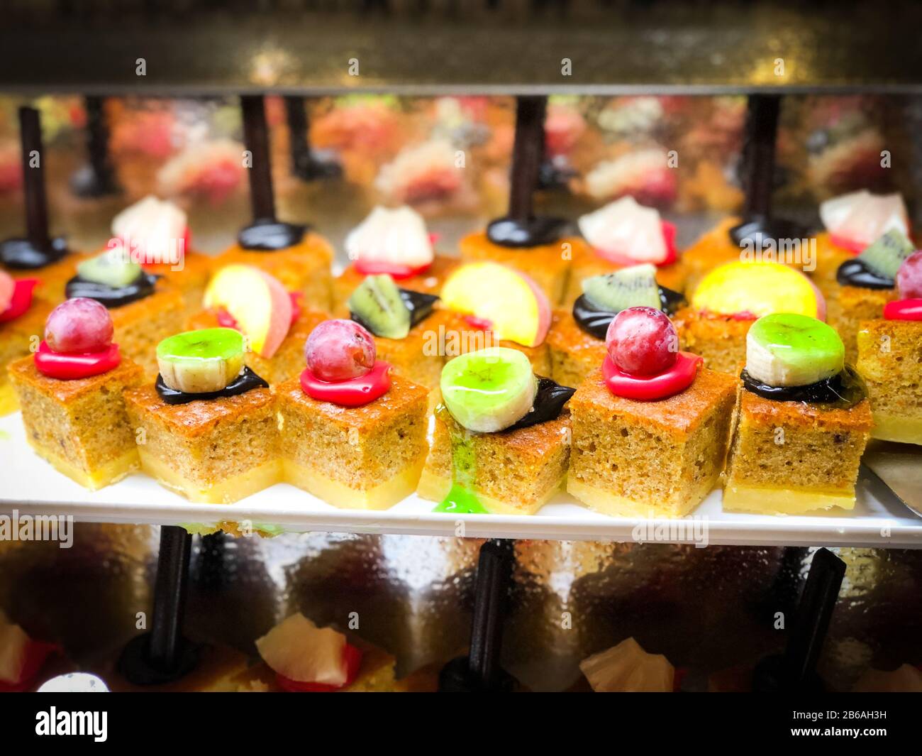 mix mini cakes & sweets with fresh fruits & glazed topping Stock Photo ...