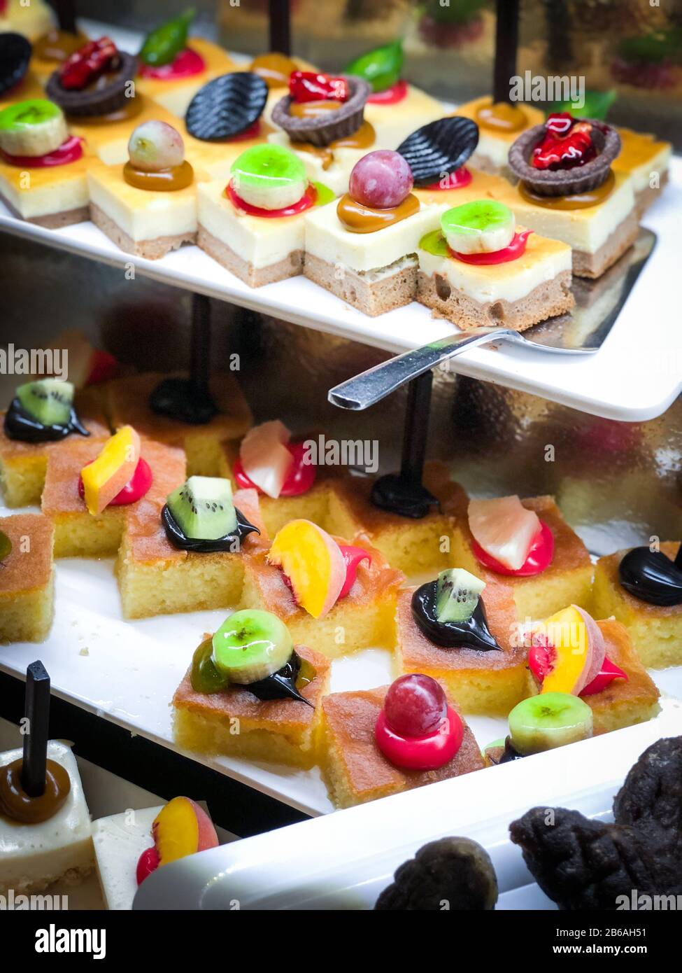 mix mini cakes & sweets with fresh fruits & glazed topping Stock Photo ...