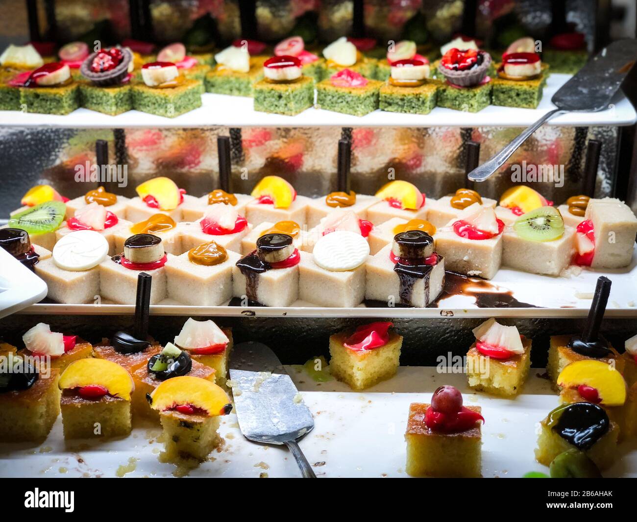 mix mini cakes & sweets with fresh fruits & glazed topping Stock Photo ...