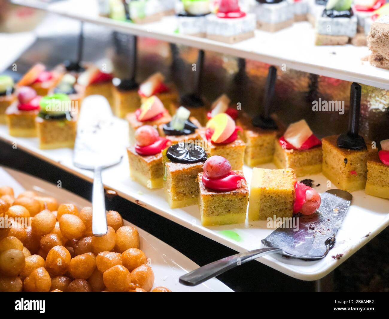 mix mini cakes & sweets with fresh fruits & glazed topping Stock Photo ...