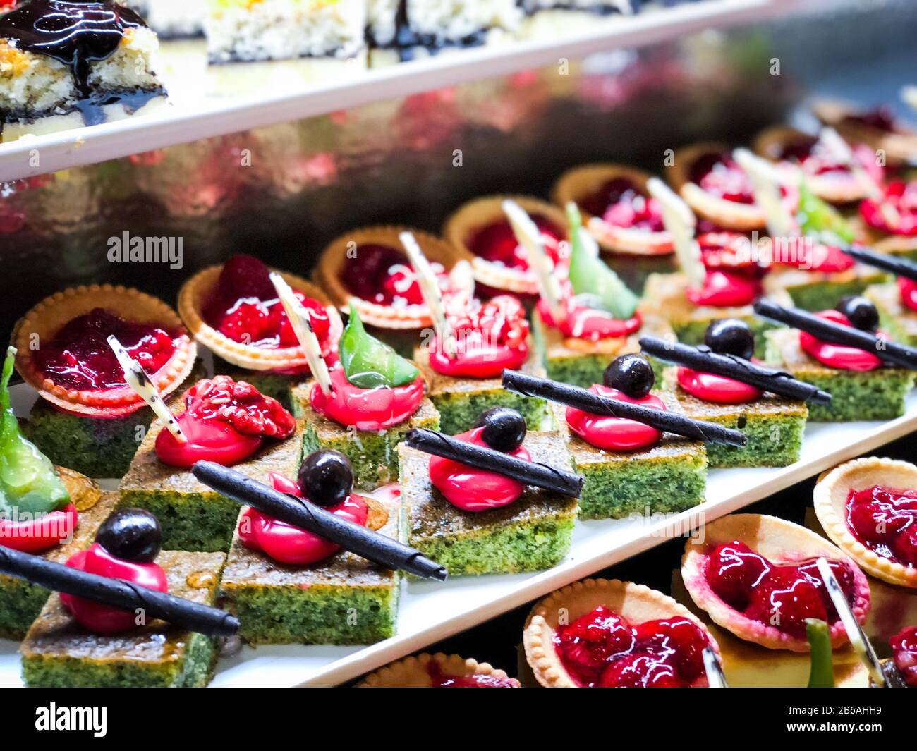 mix mini cakes & sweets with fresh fruits & glazed topping Stock Photo ...