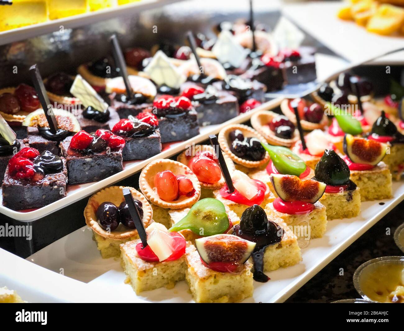 mix mini cakes & sweets with fresh fruits & glazed topping Stock Photo ...