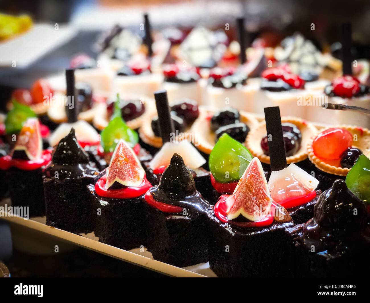 mix mini cakes & sweets with fresh fruits & glazed topping Stock Photo ...