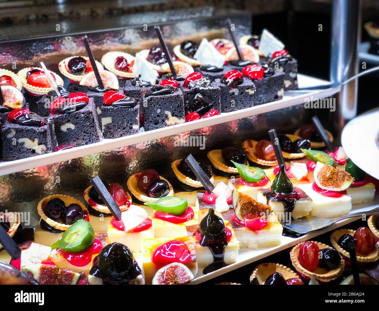 mix mini cakes & sweets with fresh fruits & glazed topping Stock Photo ...