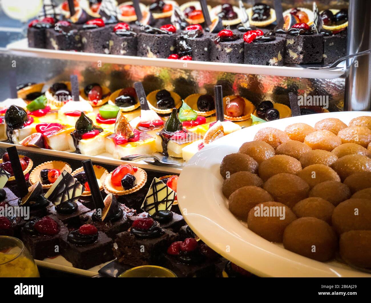 mix mini cakes & sweets with fresh fruits & glazed topping Stock Photo ...