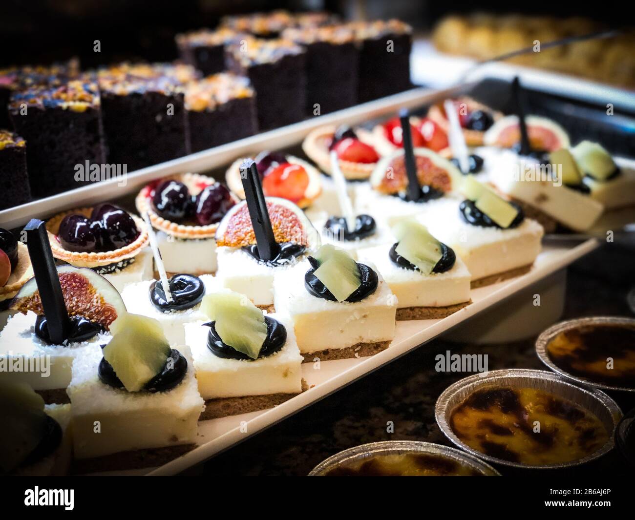 mix mini cakes & sweets with fresh fruits & glazed topping Stock Photo ...