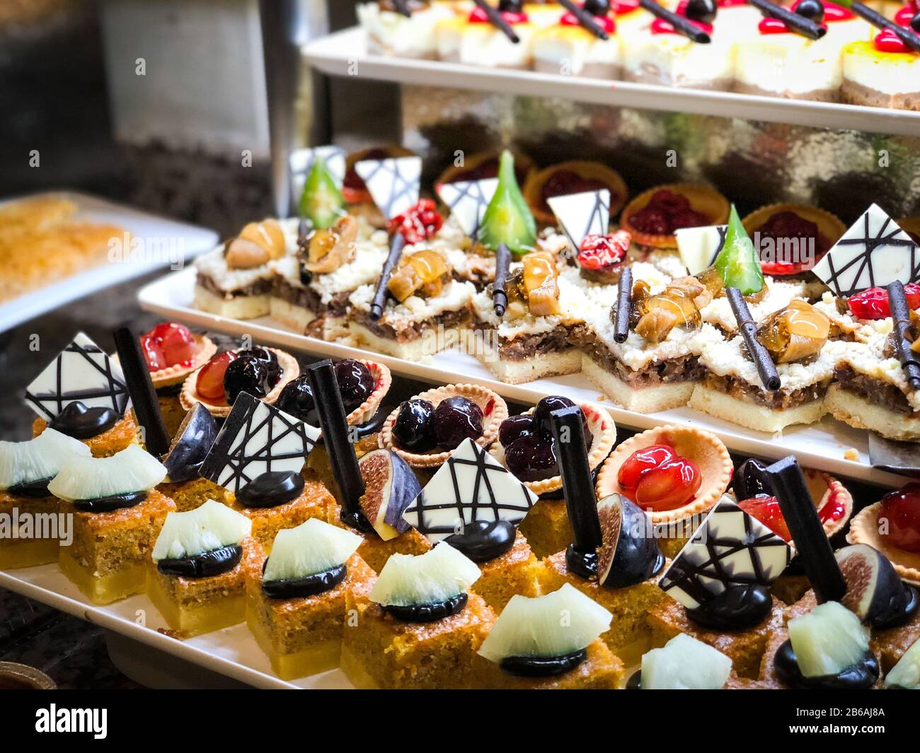 mix mini cakes & sweets with fresh fruits & glazed topping Stock Photo ...